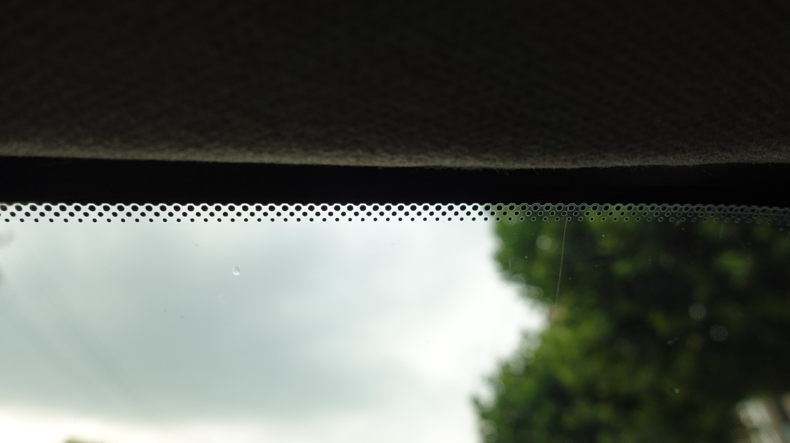 Here's What Those Little Black Dots On Car Windows And Windshields Are For