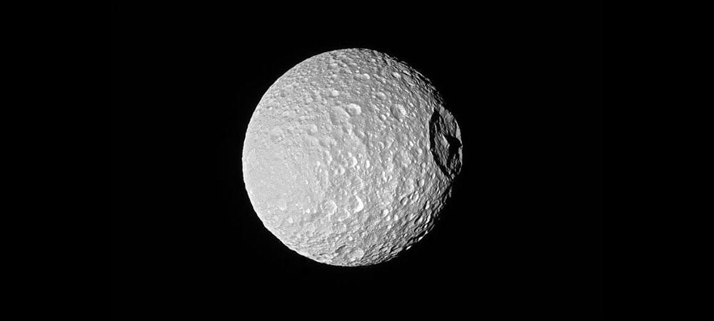 Saturn's moon looks like the Death Star in new NASA photo - SlashGear