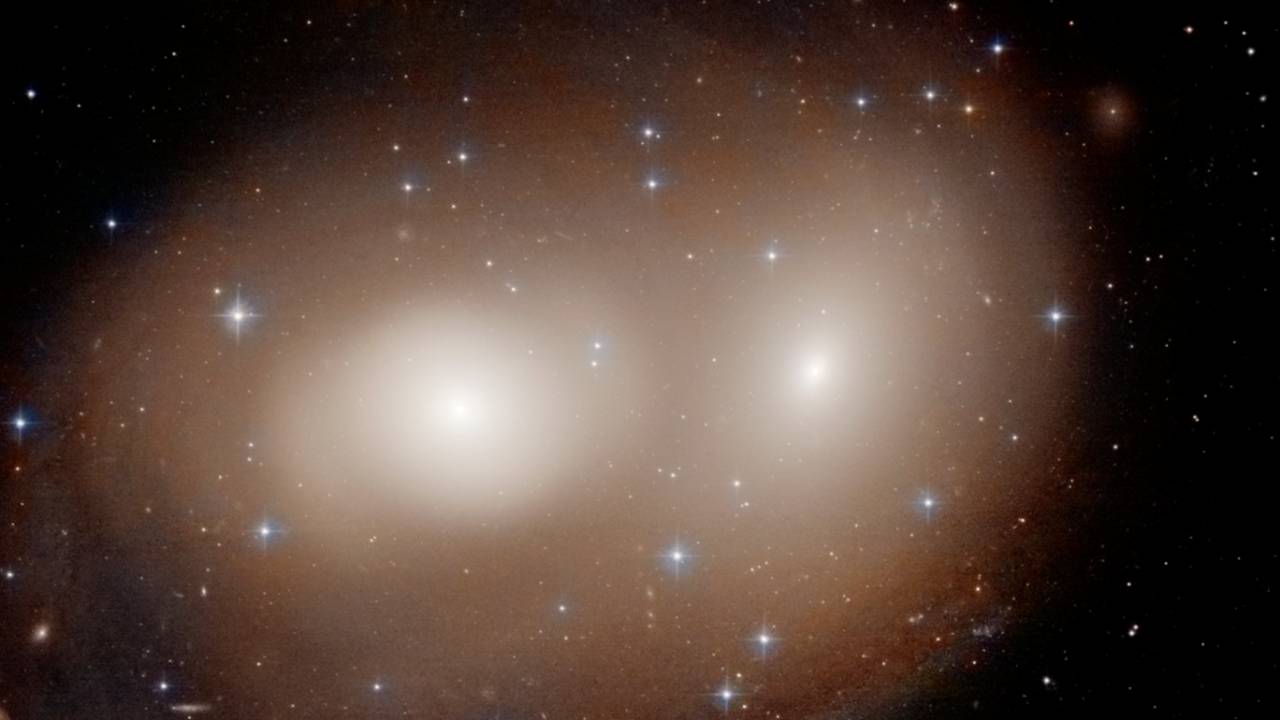 NASA shows off Greater Pumpkin galaxies with two giant glowing 'eyes ...